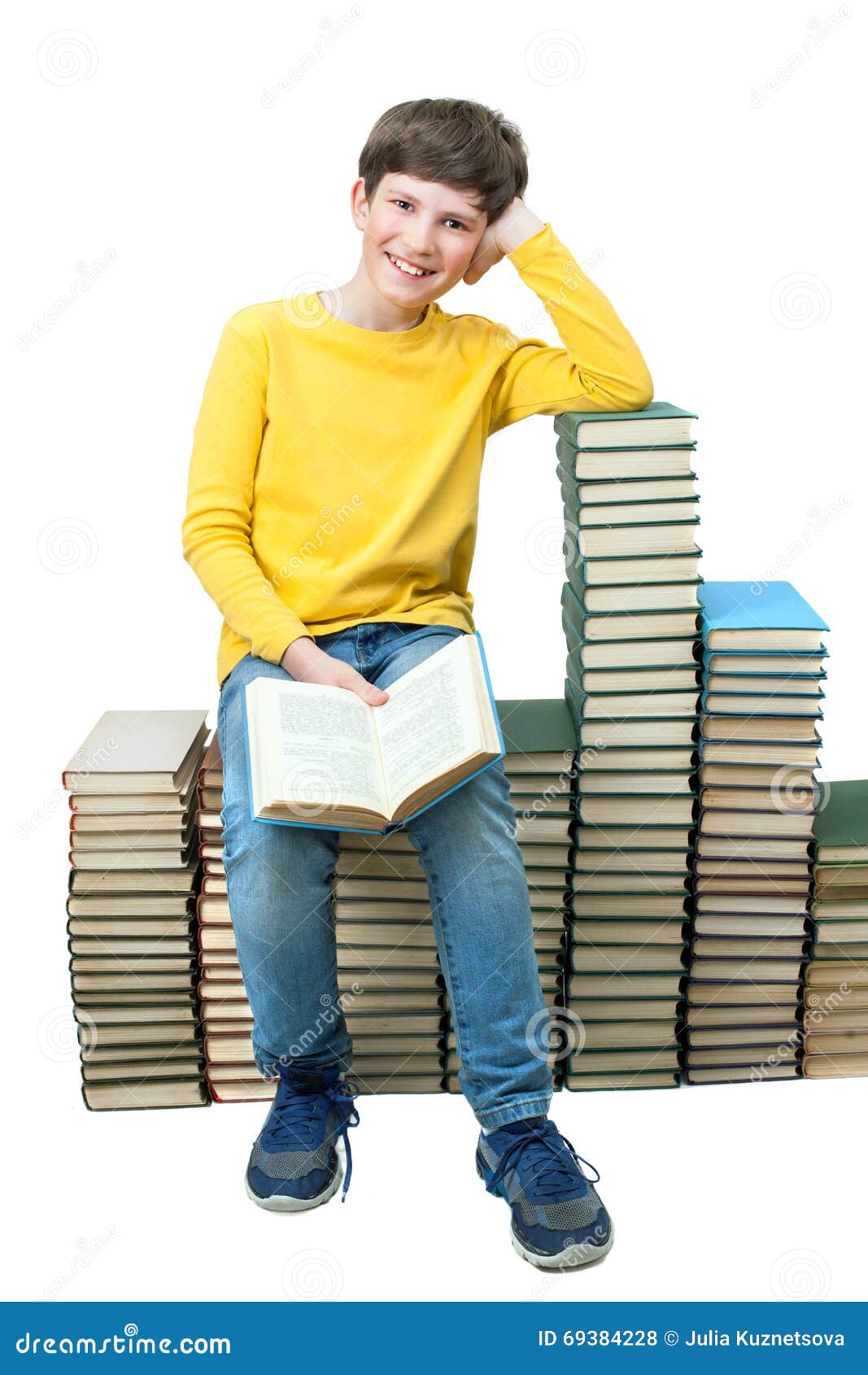 Young Boy Sitting on Stacks of Books and Reading Stock Photo - Image of ...
