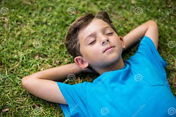 Young boy sleeping in park stock image. Image of relaxation - 77904855