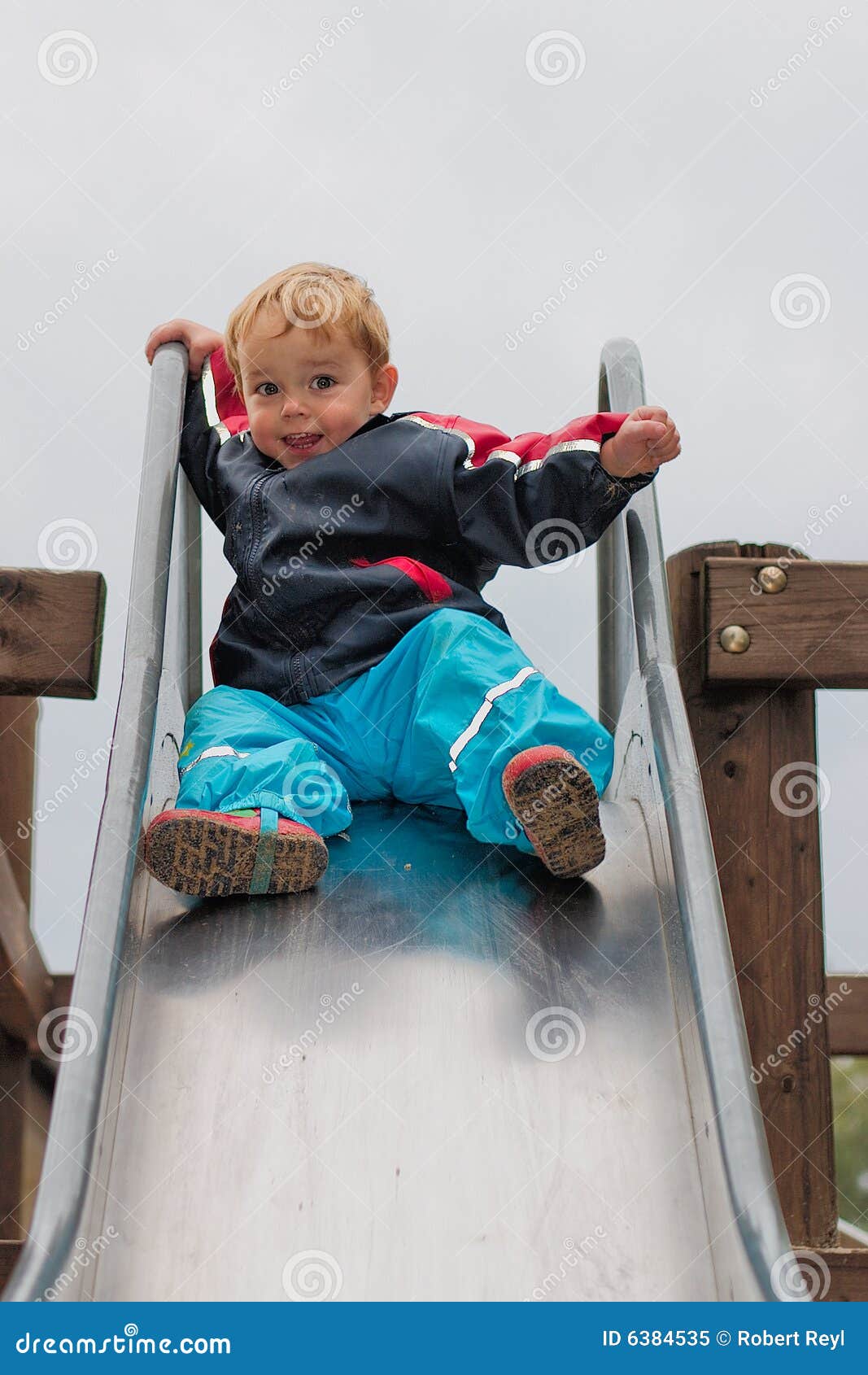 Young boy on slide stock image. Image of outdoors, male - 6384535