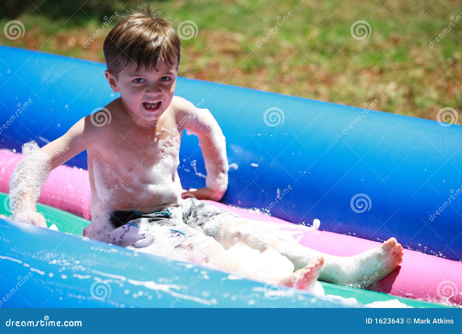 Young boy sliding stock image. Image of break, water, summertime - 1623643