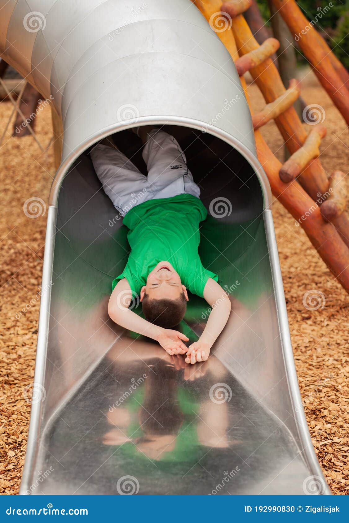 Young Boy Playing on a Slide in a Park Stock Photo - Image of joyful ...