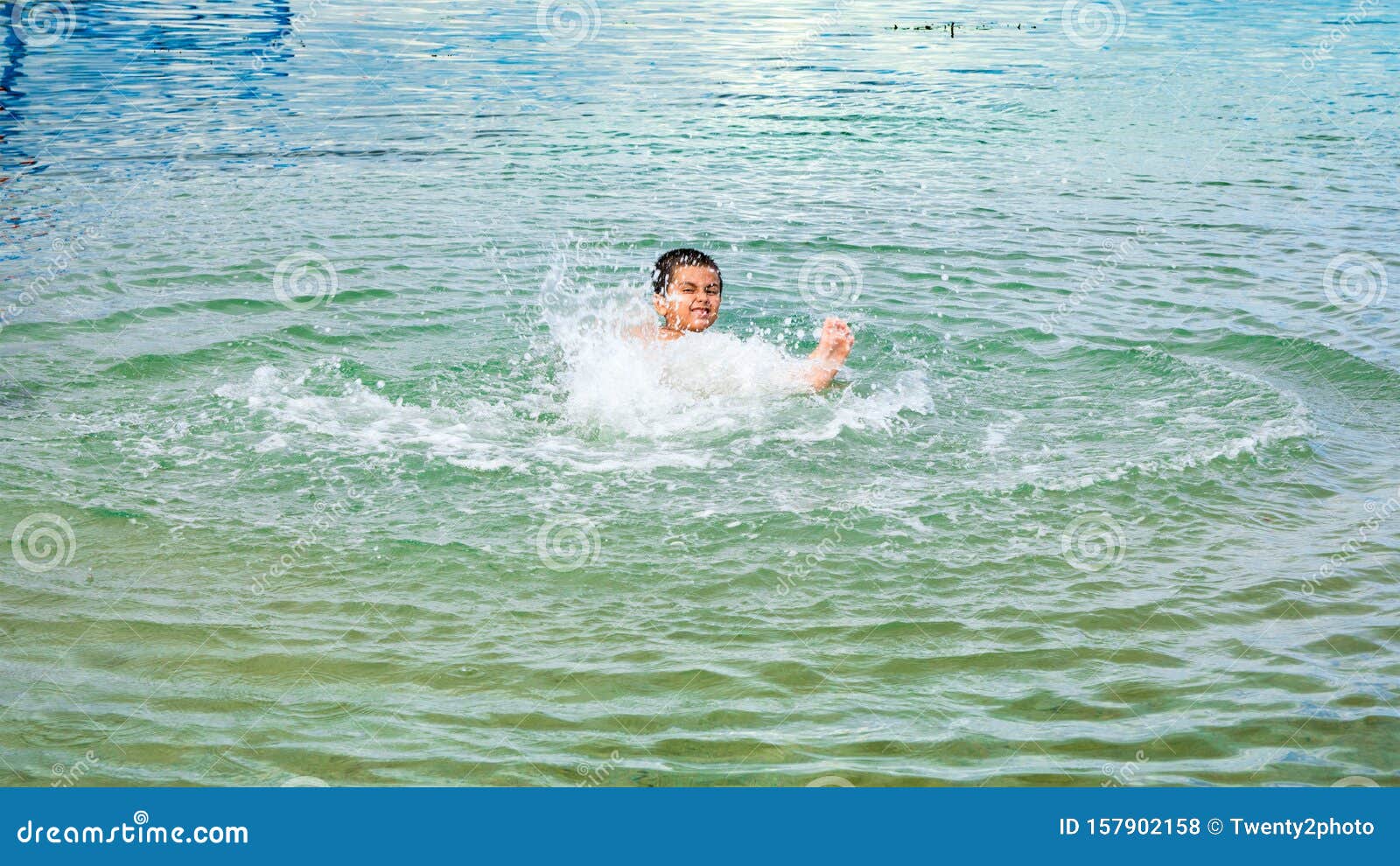 Young Boy Spalshing and Having Fun at the Beach during a Summer ...