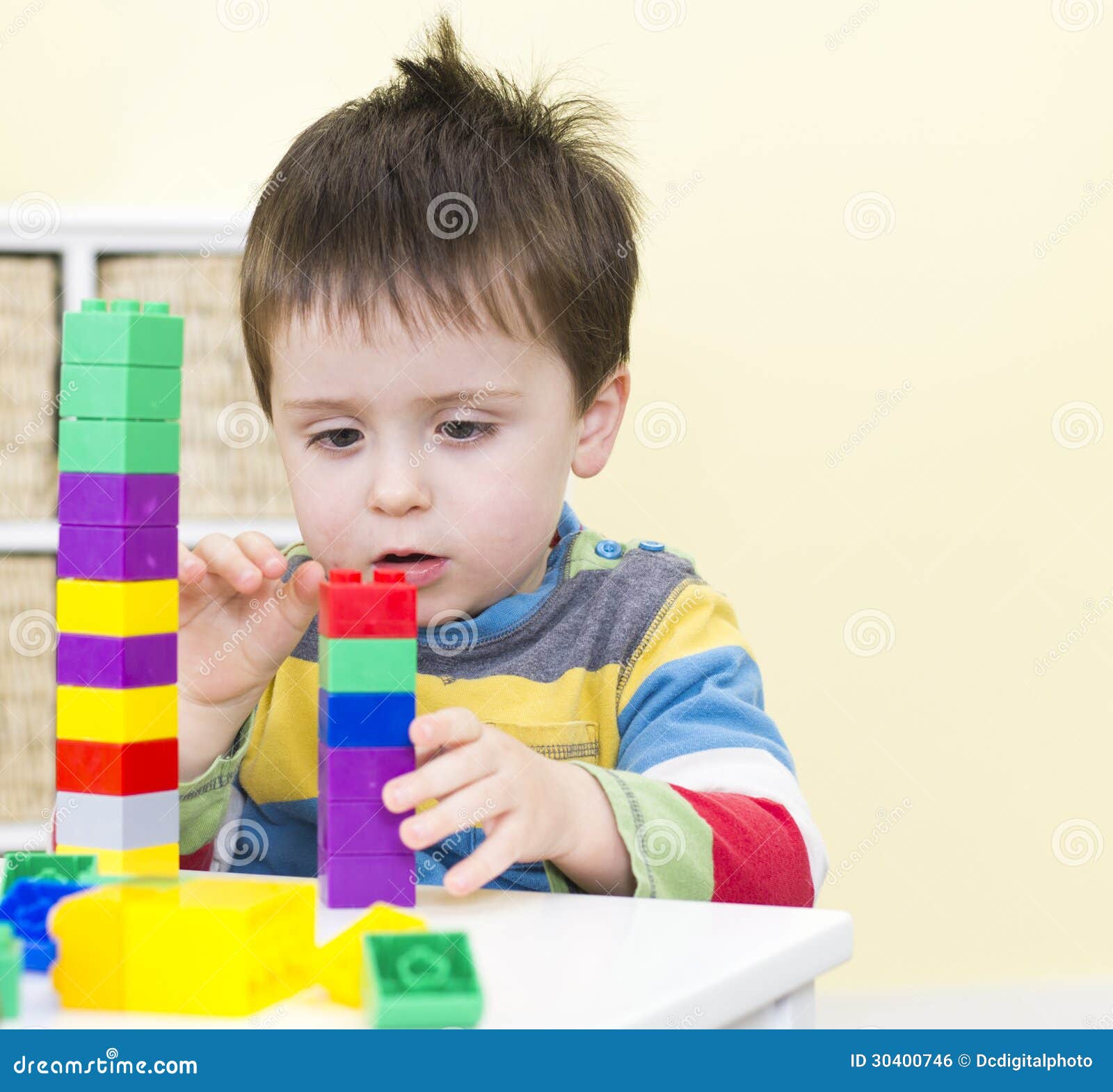 Young Boy Stacks Connecting Blocks Stock Photo - Image of concentrating ...
