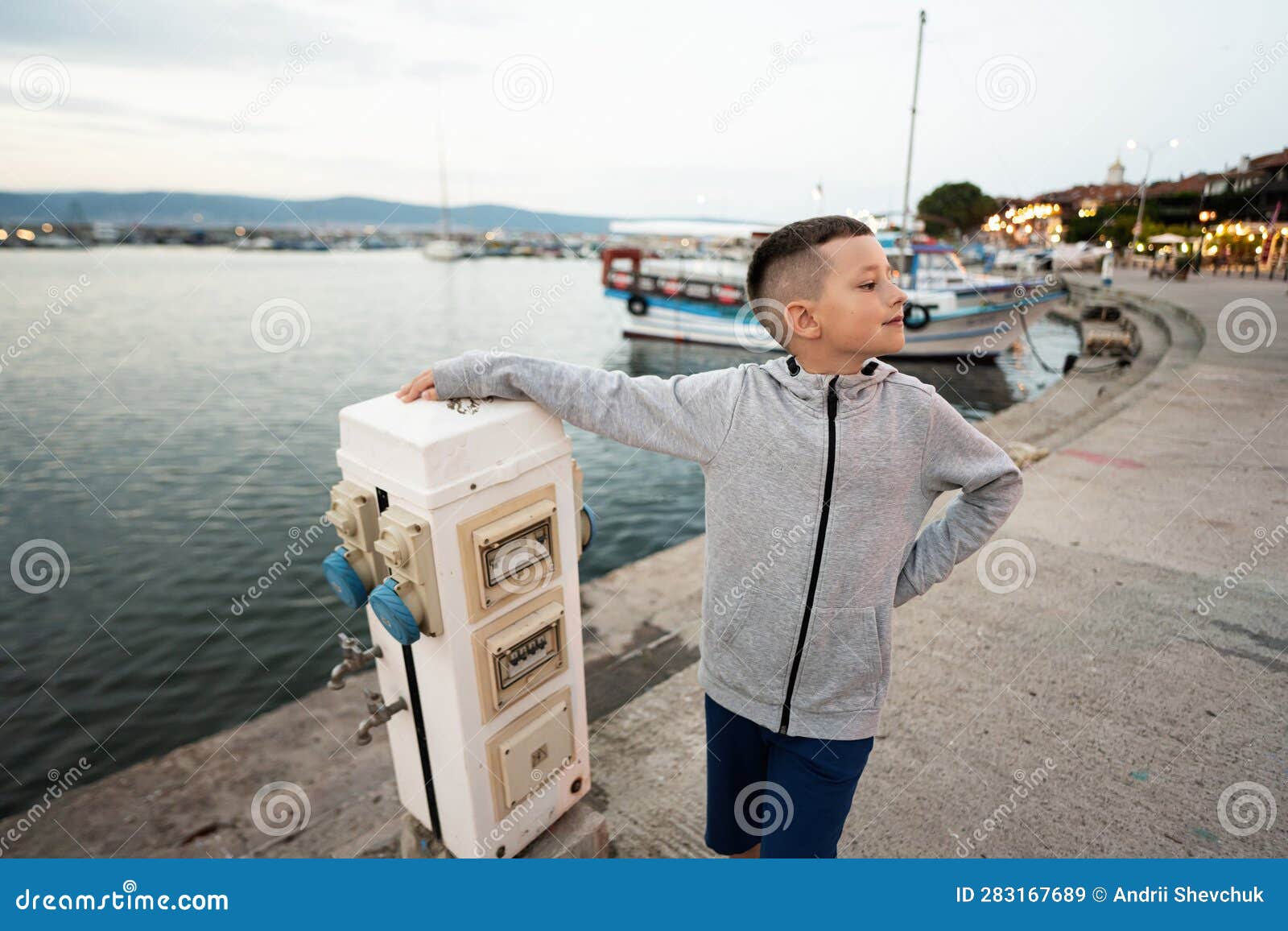 Young Boy Standing on the Pier Near the Sea Stock Image - Image of ...