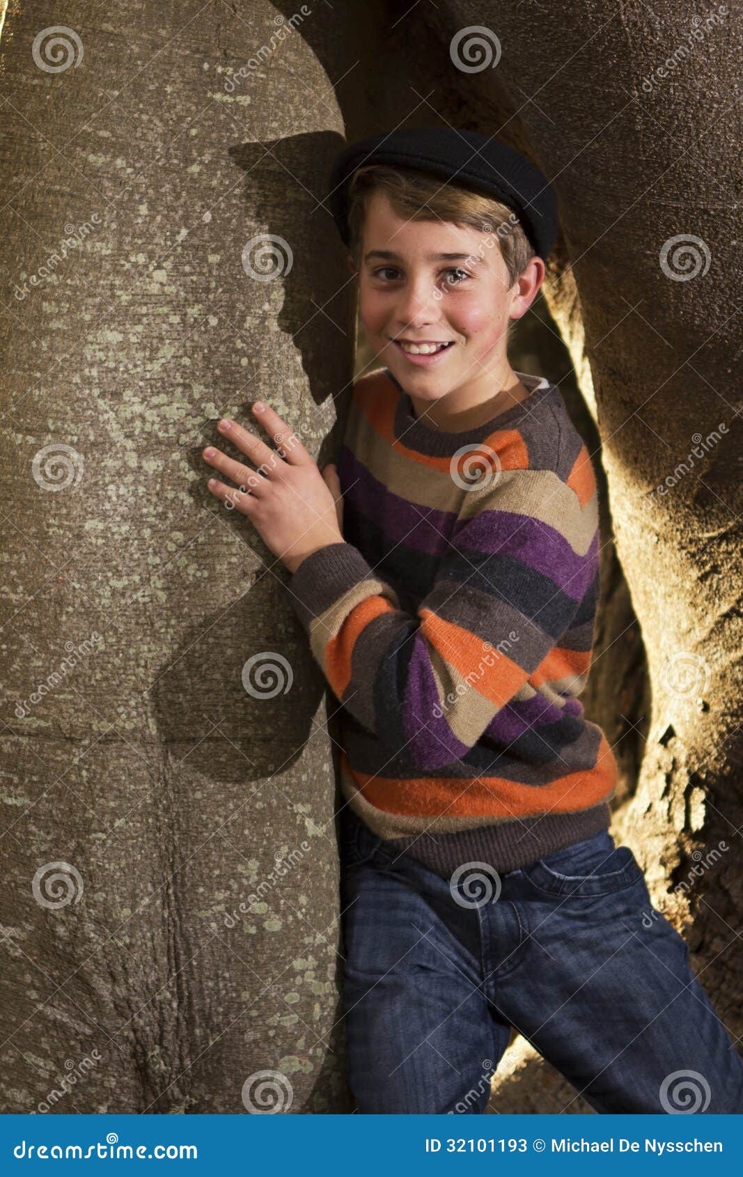 Young Boy Standing beside Tree Trunk Stock Image - Image of young ...