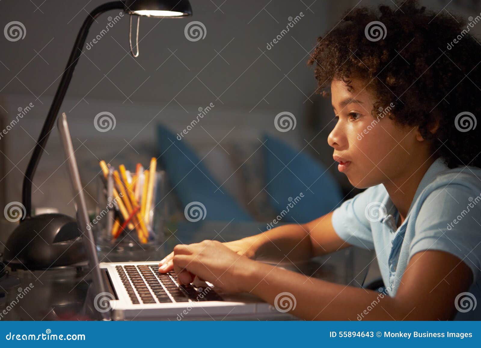 Young Boy Studying at Desk in Bedroom in Evening on Laptop Stock Image ...