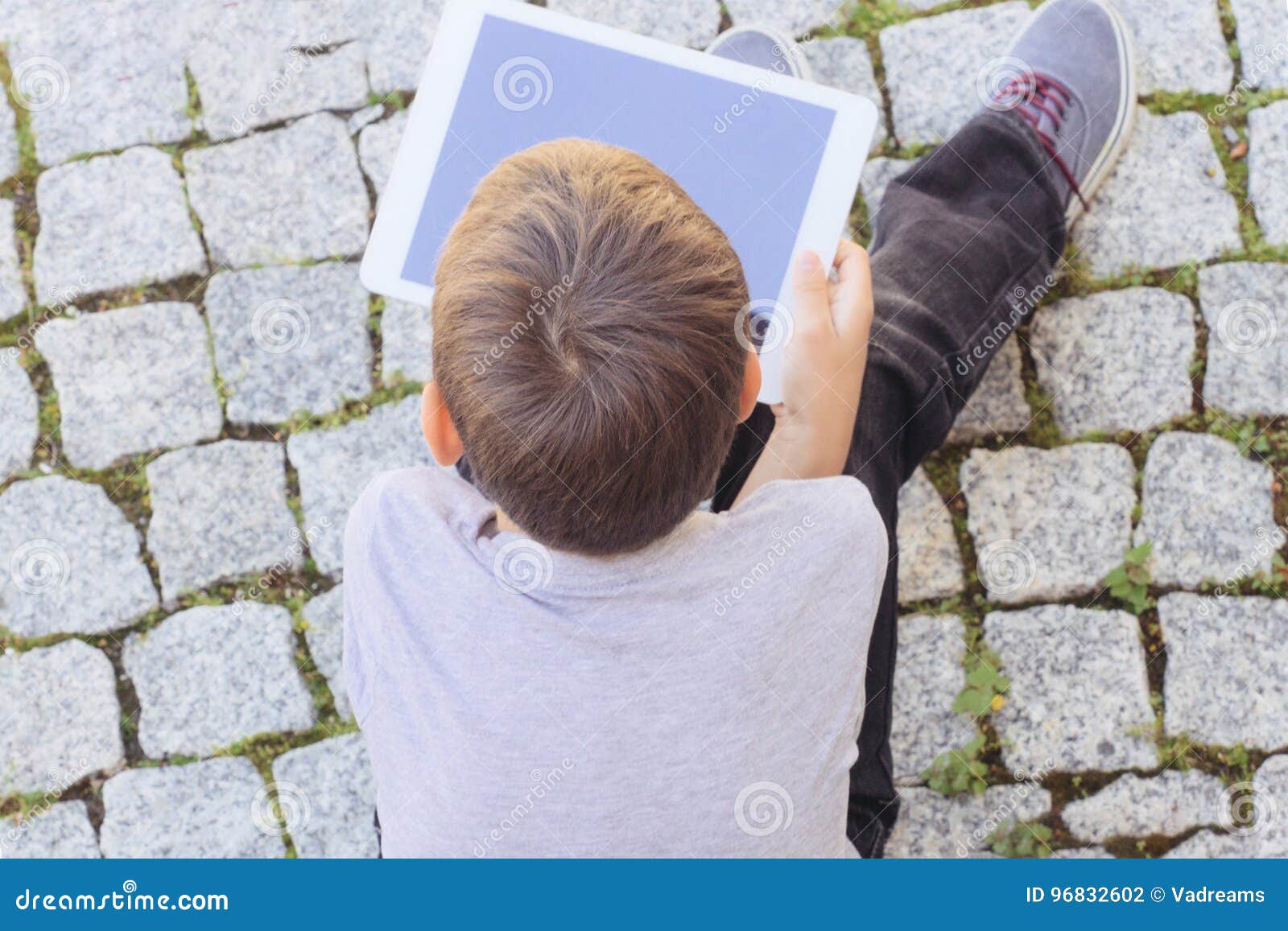 Young Boy with Tablet Computer Outdoors Stock Photo - Image of sitting ...