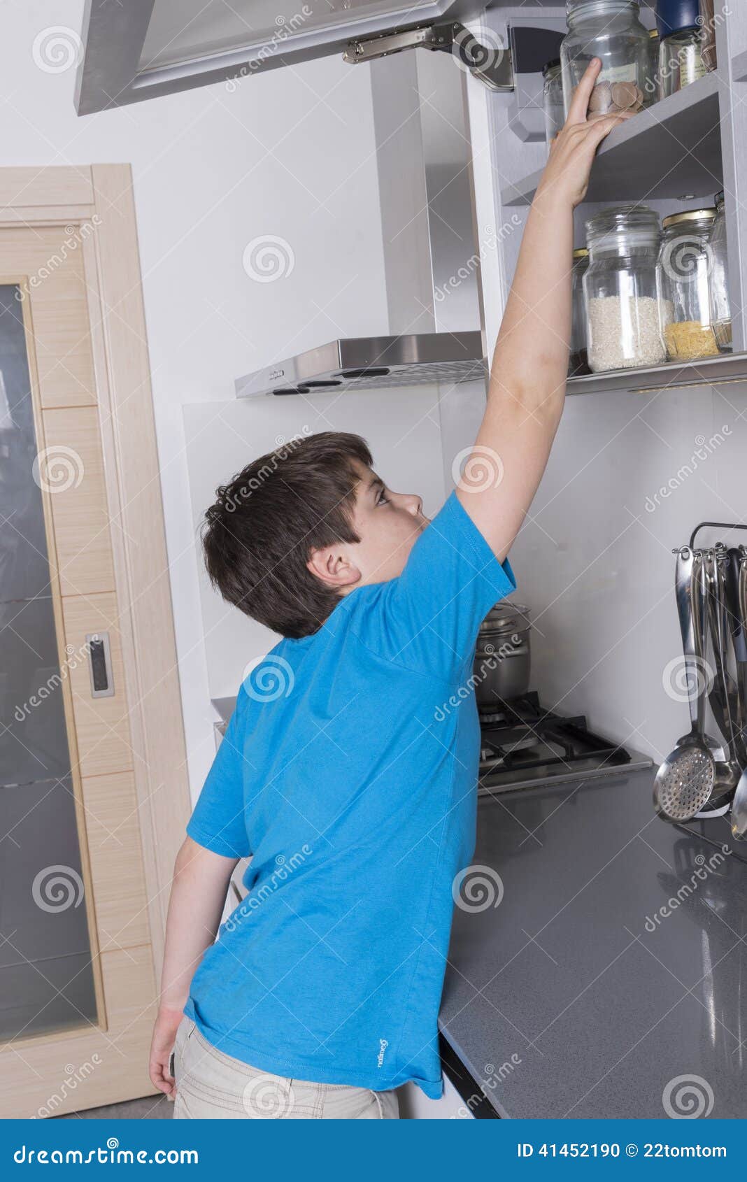 Young Boy Taking Candy from a High Kitchen Cabinet Stock Photo - Image ...
