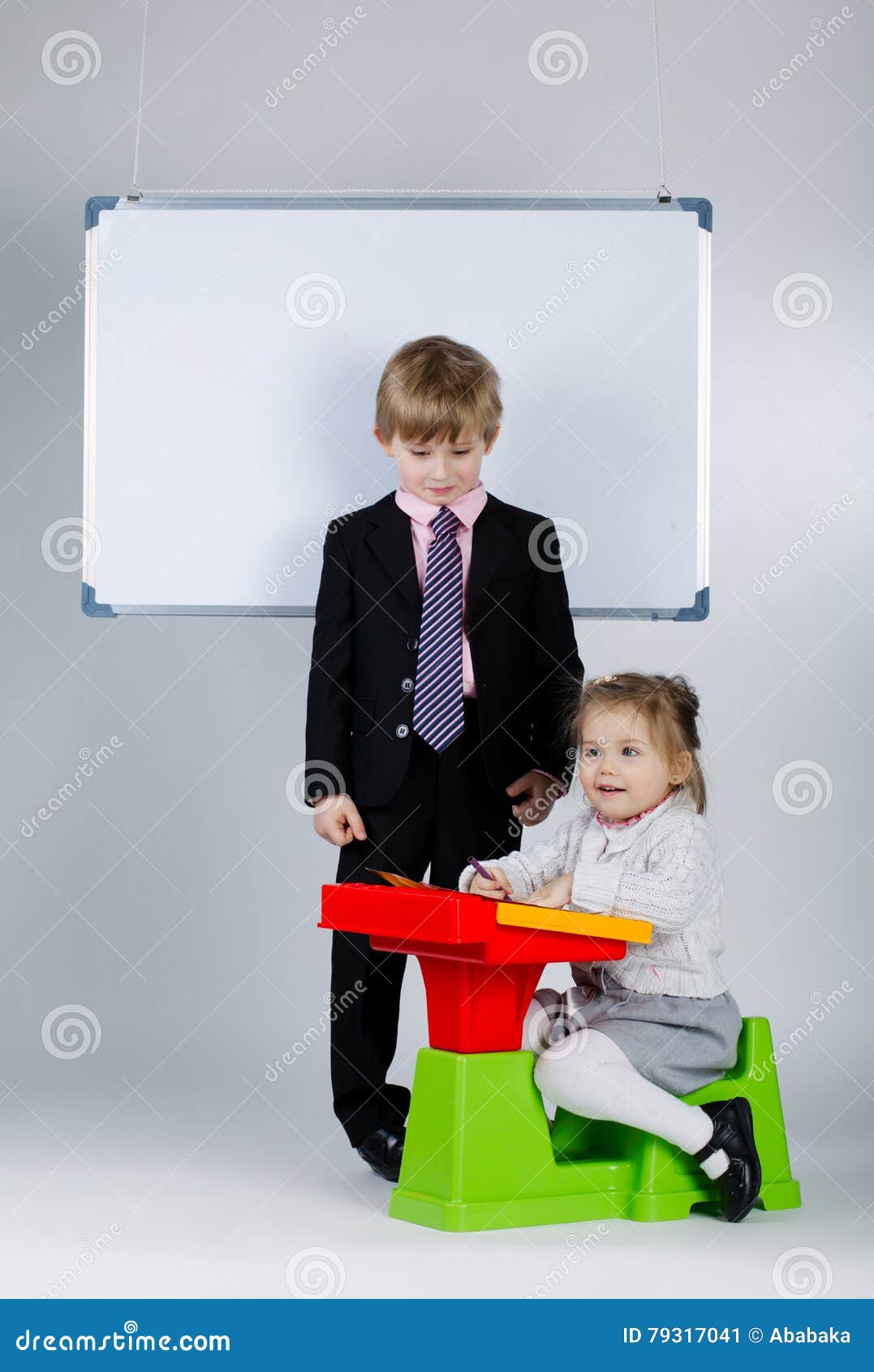 Young boy teaching sister stock image. Image of child - 79317041
