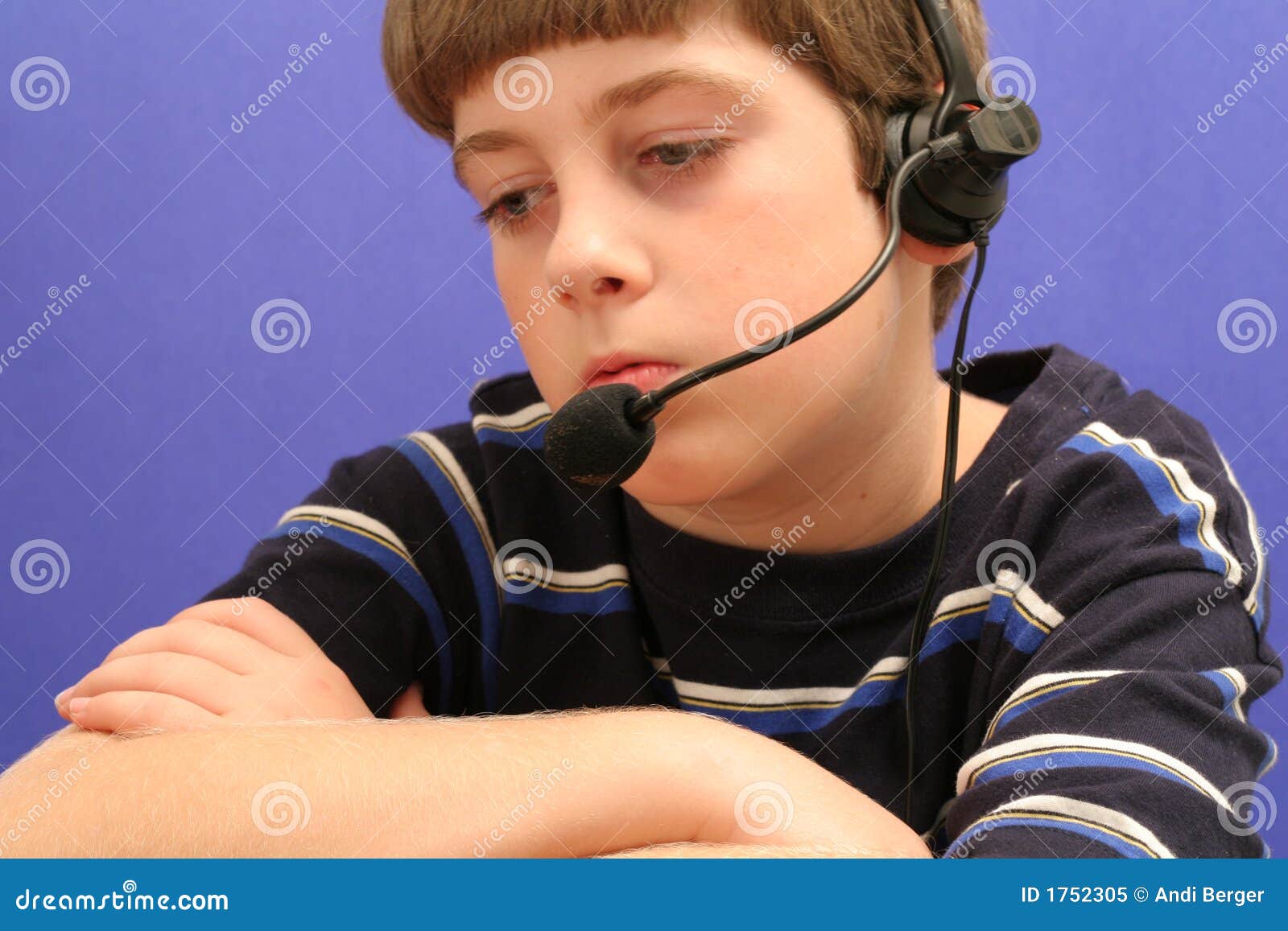 Young Boy On Telephone Blue Background Picture. Image: 1752305