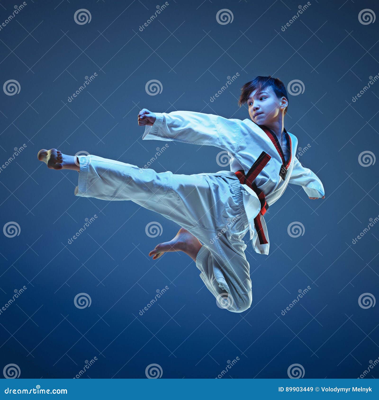 Young Boy Training Karate on Blue Background Stock Image - Image of ...