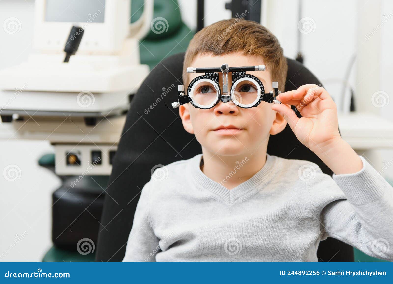 Young Boy Undergoing Eye Test with Spectacles in Medical Clinic. Stock ...