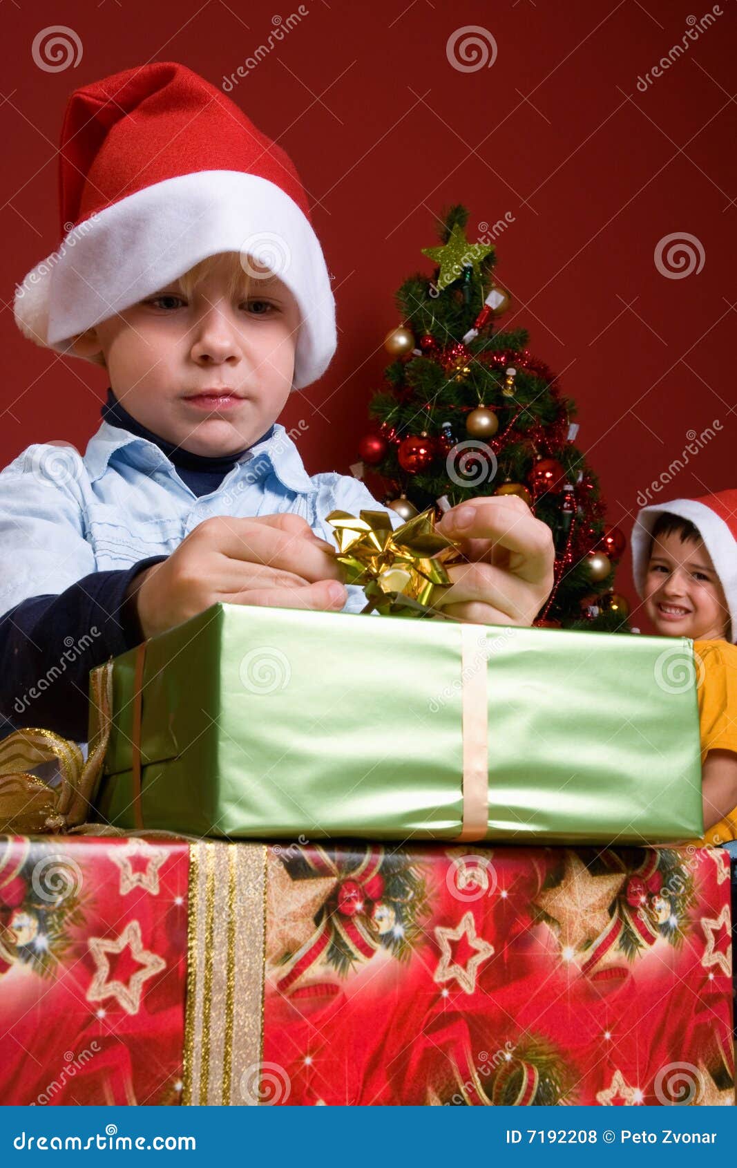 Young Boy Unwrapping Christmas Gift Stock Photo - Image of gift, female ...