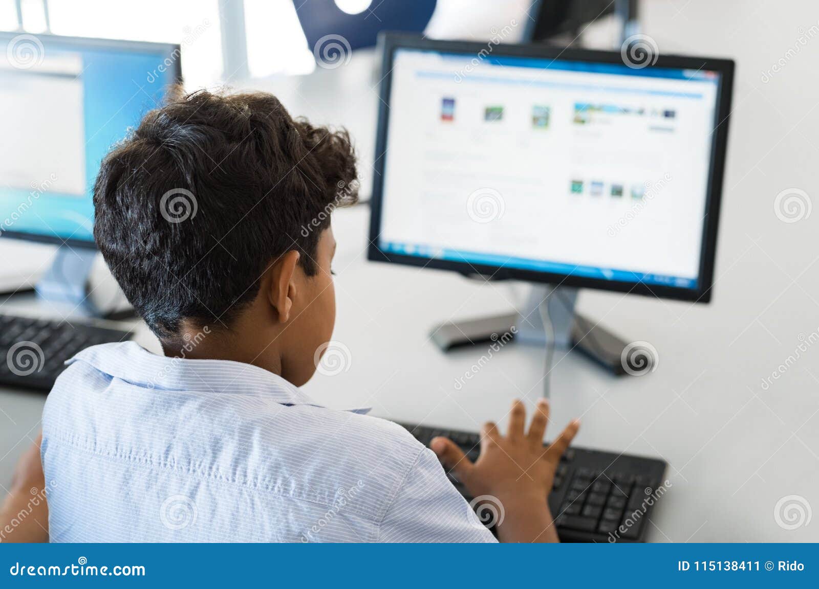 Young boy using computer stock image. Image of typing - 115138411