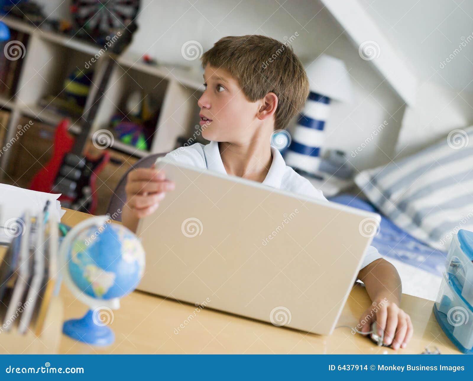 Young Boy Using a Laptop in His Bedroom Stock Photo - Image of home ...