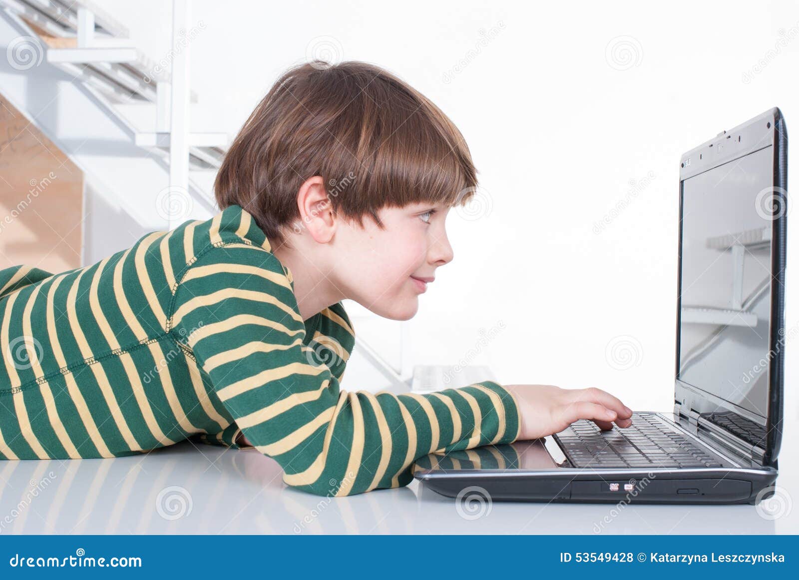 Young boy using a laptop stock photo. Image of male, learn - 53549428