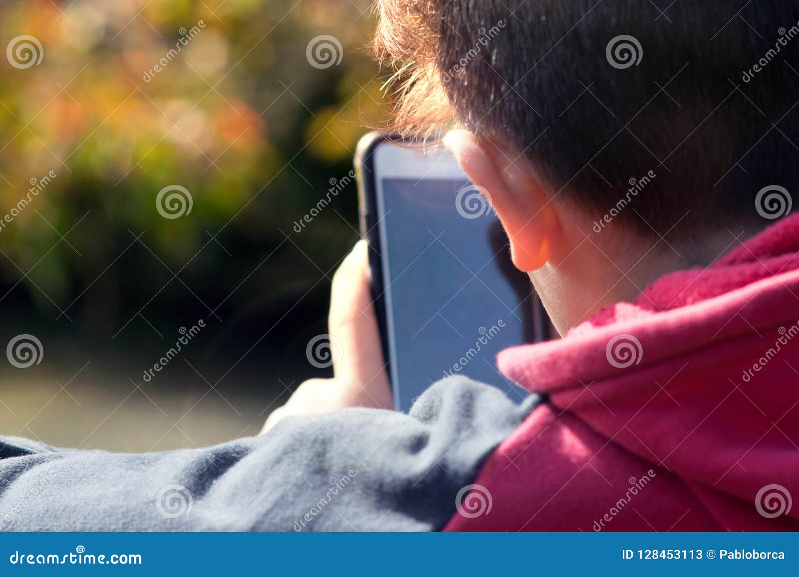 Young Boy Using Phone Outdoors Stock Image - Image of cell, childhood ...