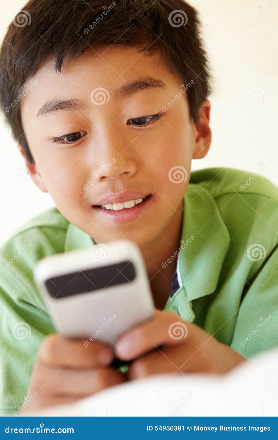 Young boy using smartphone stock image. Image of race - 54950381