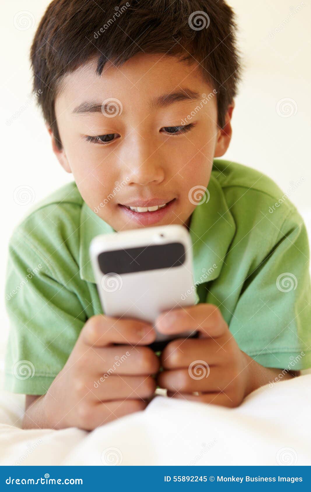 Young boy using smartphone stock image. Image of male - 55892245