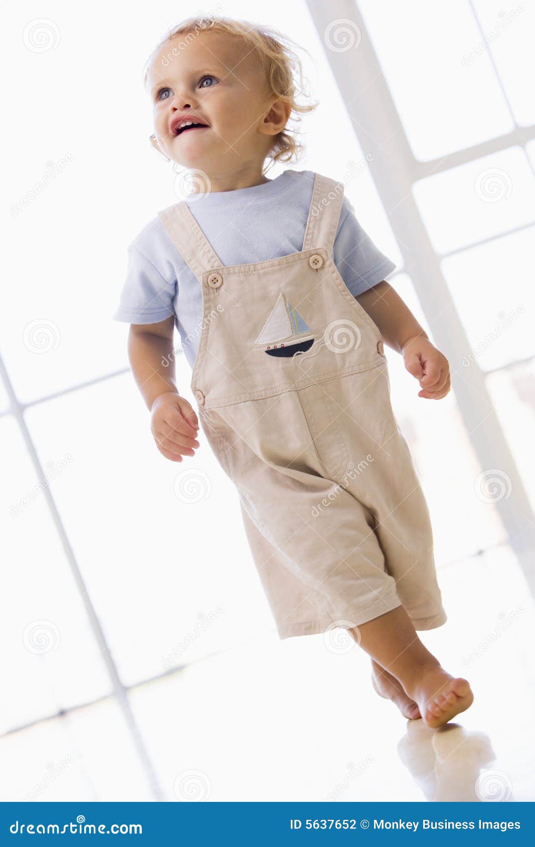 Young Boy Walking Indoors Smiling Stock Photo - Image of children ...
