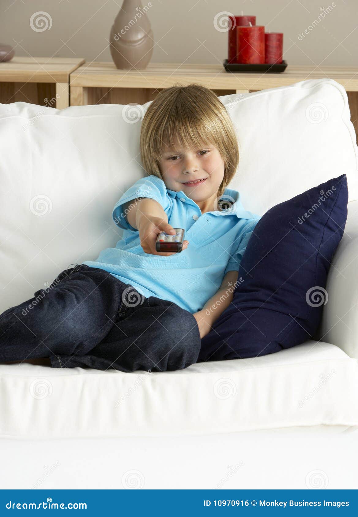 Young Television Addict Man Sitting On Home Sofa Watching TV And Eating ... Young Television Addict Man Sitting On Home Sofa Watching TV And Eating ...