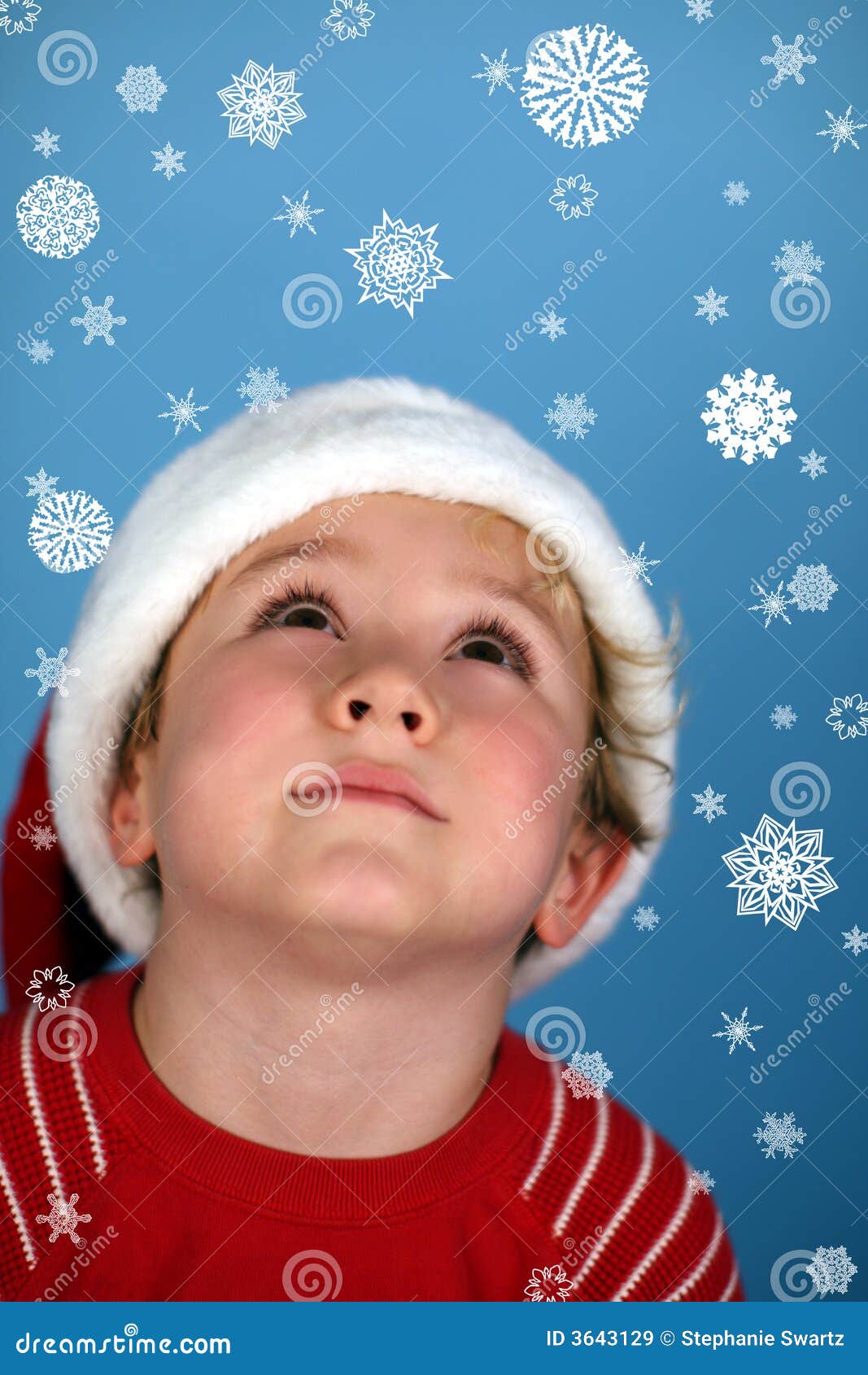 A Young Boy Wearing a Santa Hat Stock Image - Image of toddler, blue ...