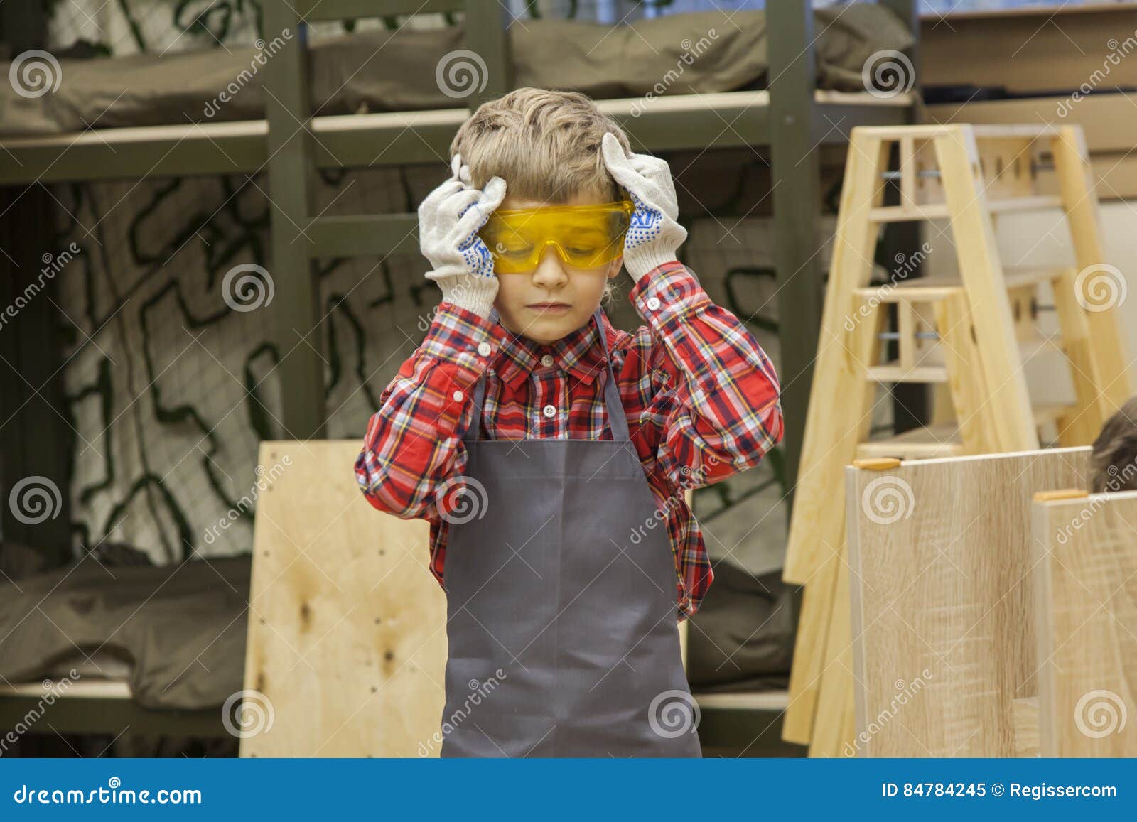 Young Boy in Work Apron Wearing Protective Goggles Stock Image - Image ...