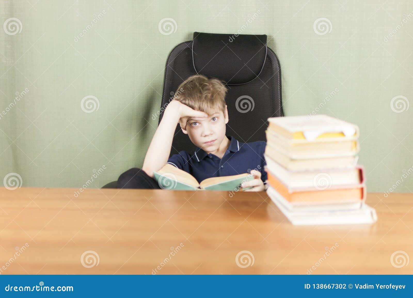 A Young Boy is Working on His Homework at the Table. Back To School ...