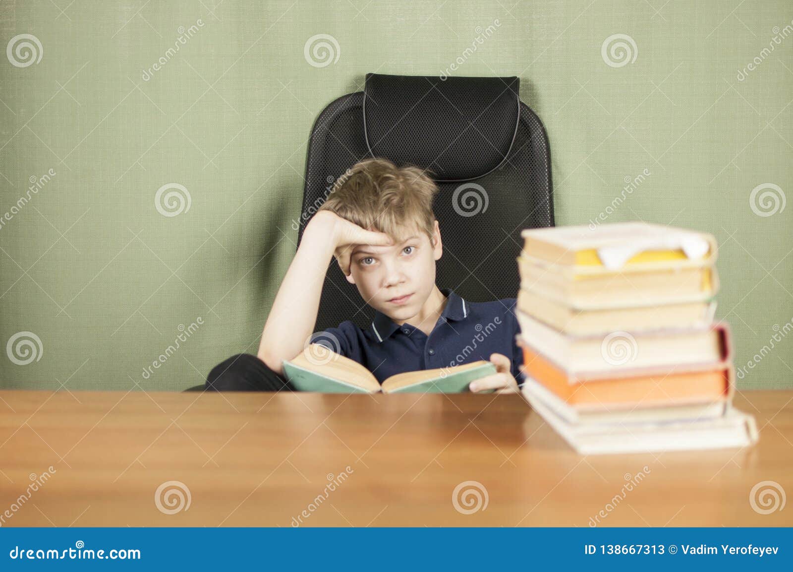 A Young Boy is Working on His Homework at the Table. Back To School ...