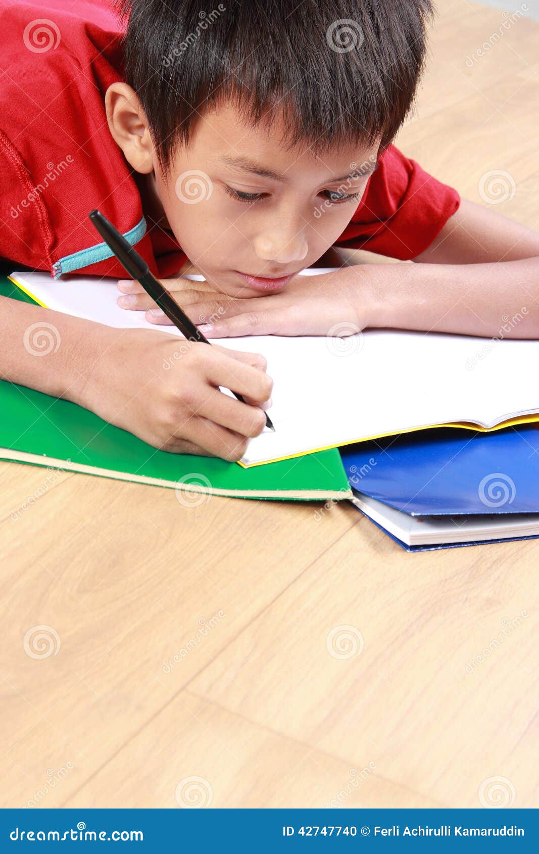 Young Boy Writing Something on the Book Stock Photo - Image of casual ...