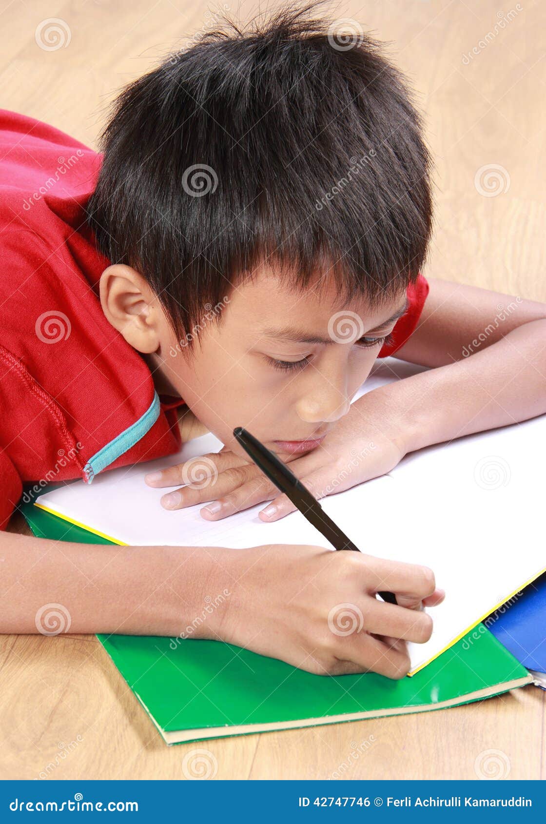Young Boy Writing Something on the Book Stock Photo - Image of pressure ...