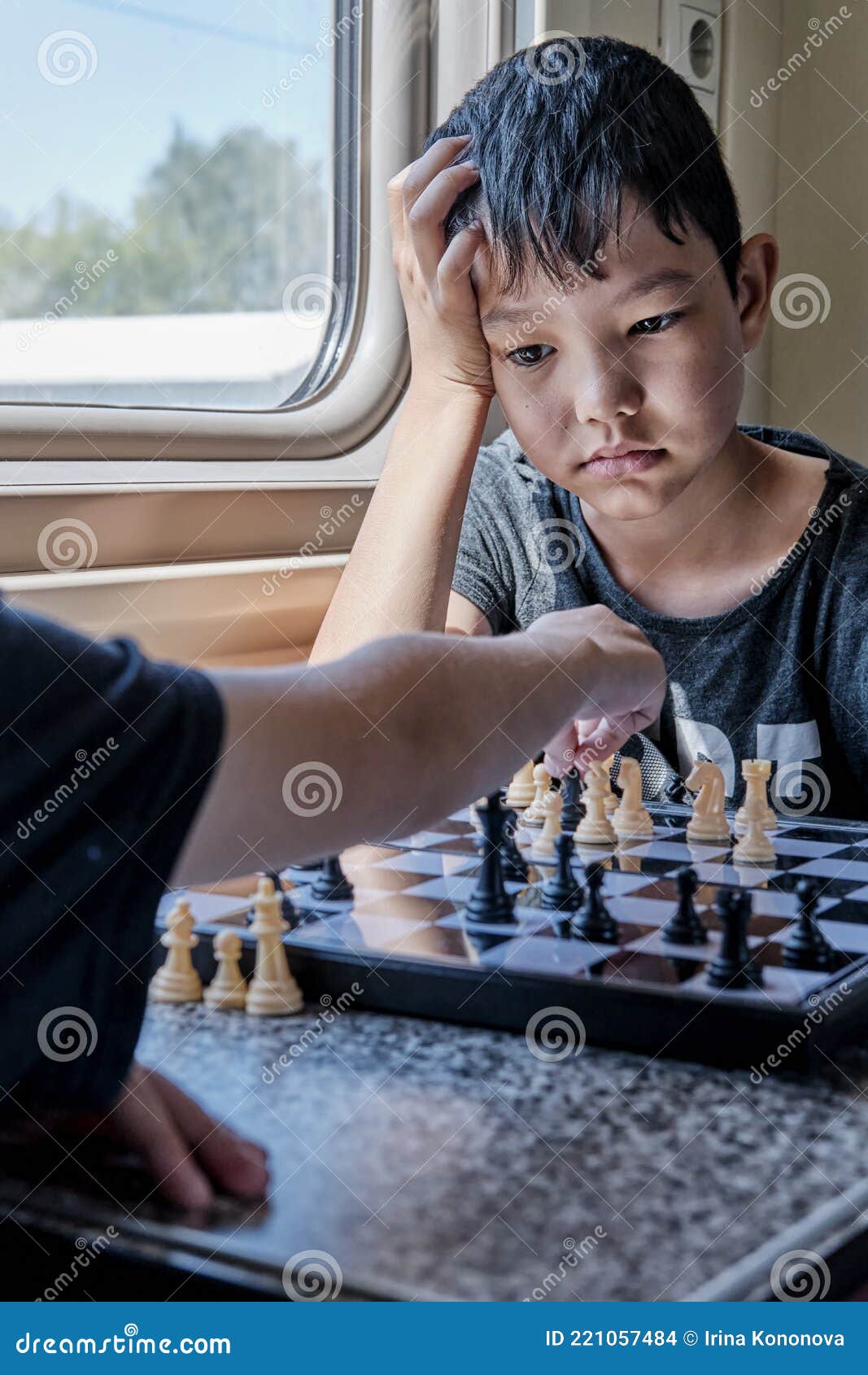 Young boys playing chess stock photo. Image of human - 221057484