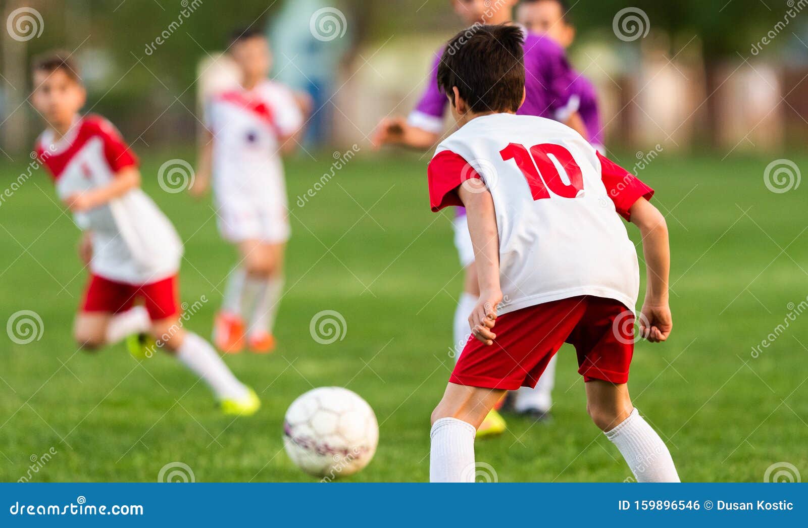 Young boys playing soccer stock photo. Image of sports - 159896546