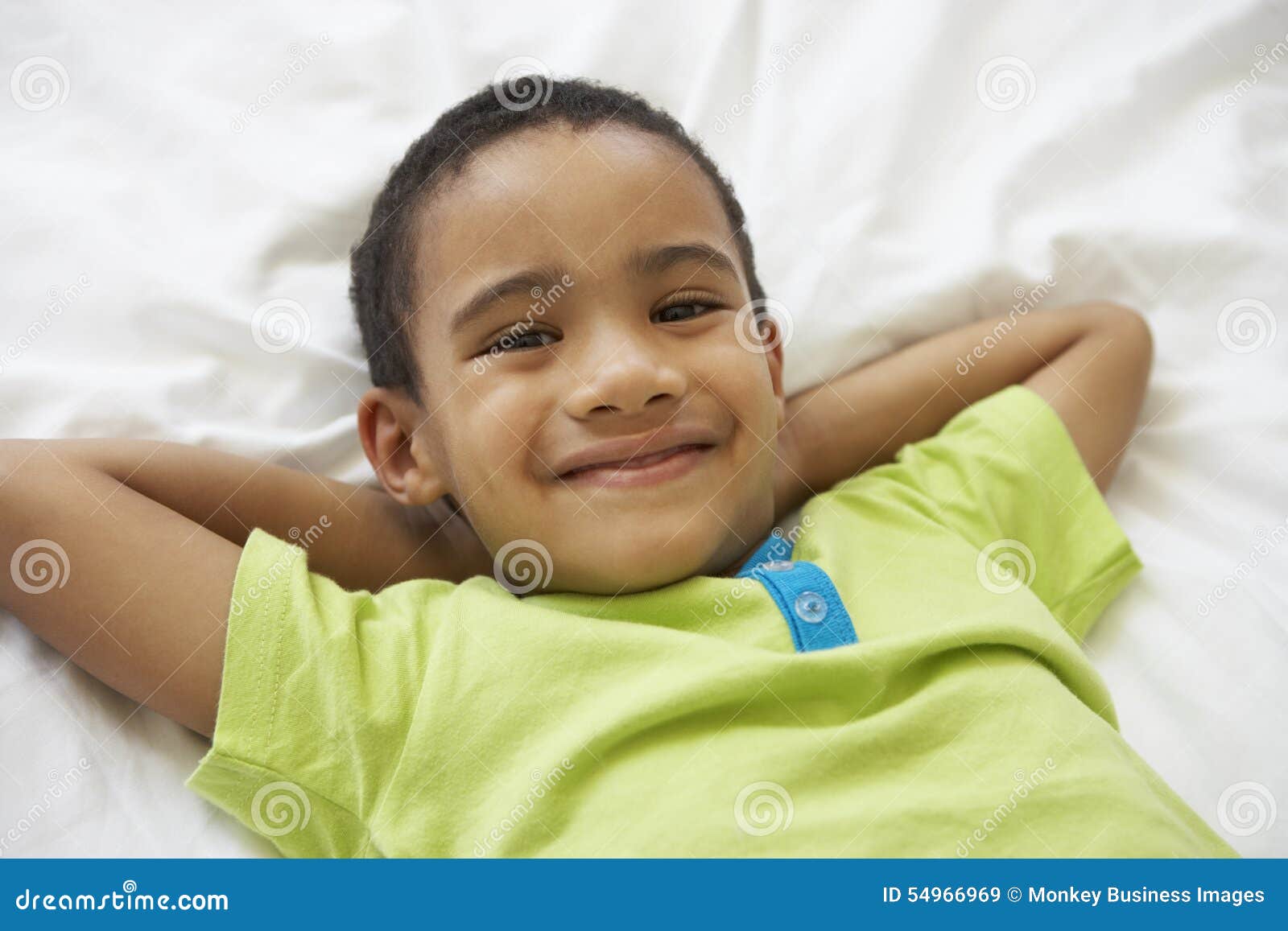 Young Boys Relaxing on Bed stock image. Image of mixed - 54966969