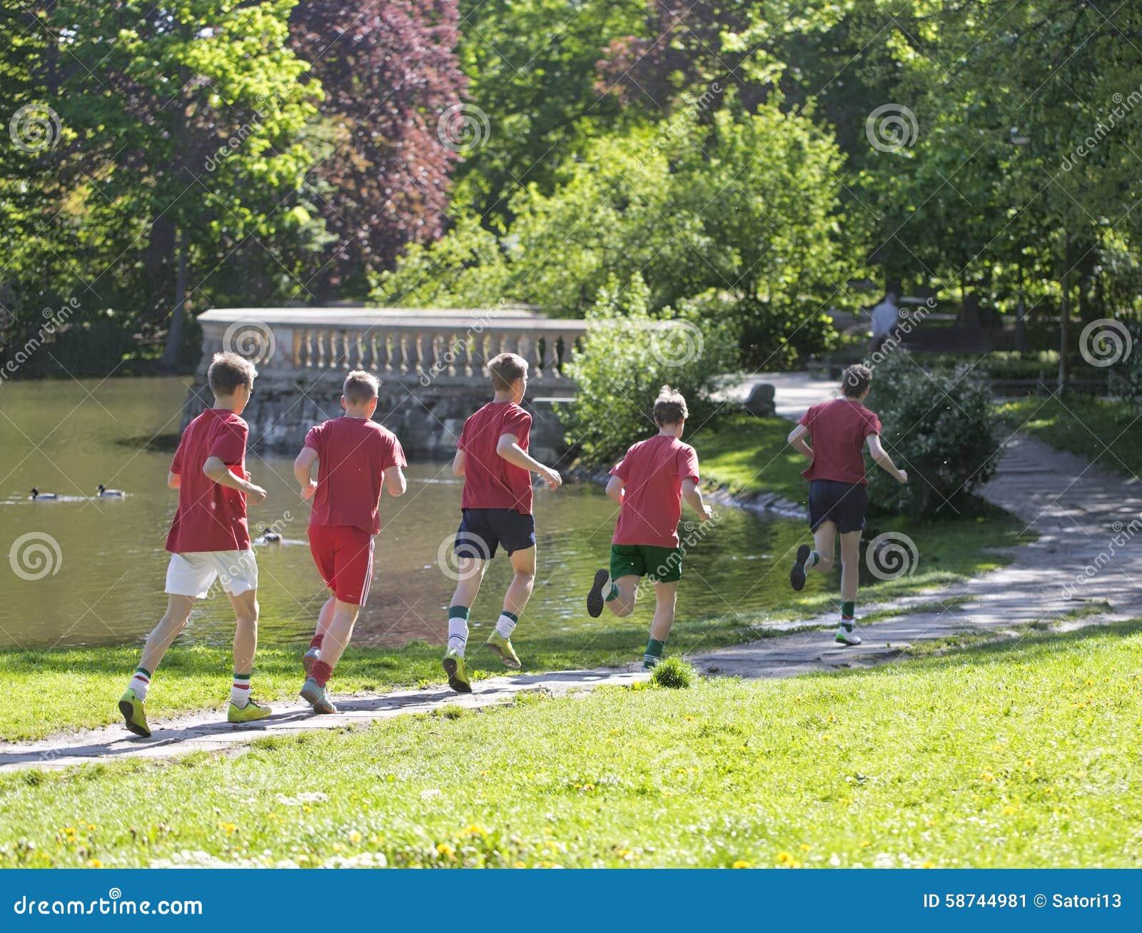 Young boys run in park editorial photo. Image of meadow - 58744981