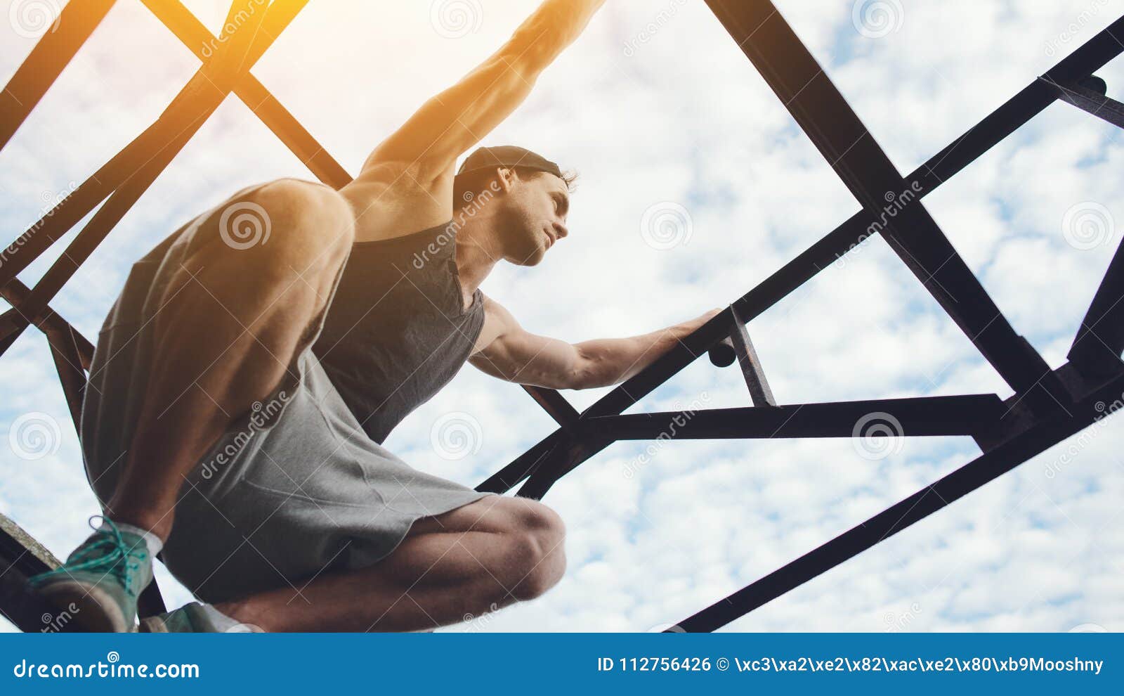 Young Brave Man Climbing and Sitting on High Metal Bridge Stock Photo ...