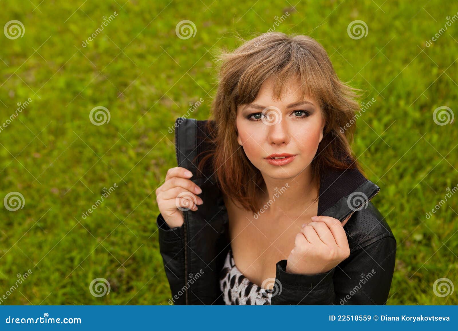 A Young Brown-haired Girl On Grass Background Stock Image ...