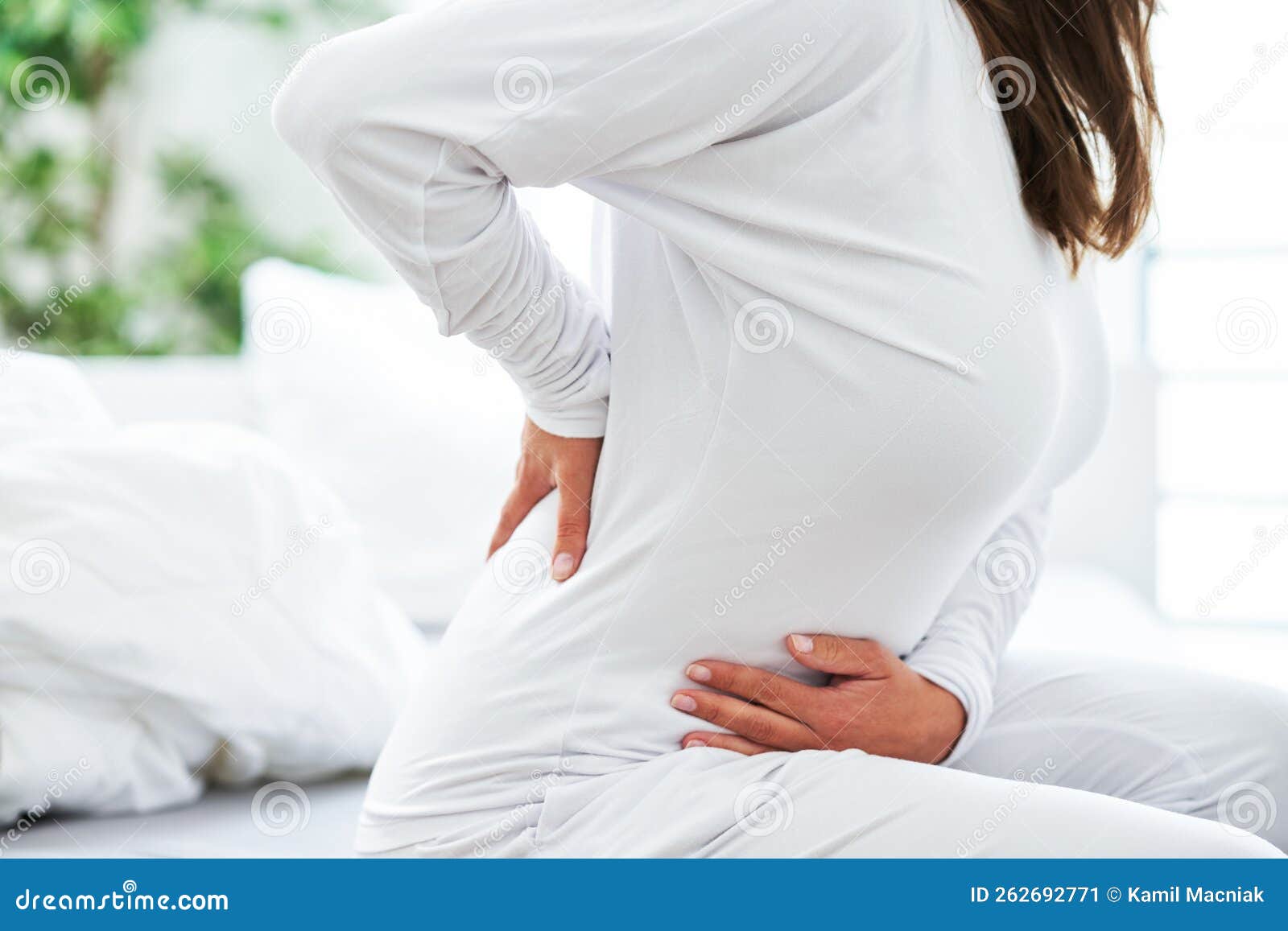 Young Brunet Woman Withe Her Back Problem in the Bed Stock Image ...