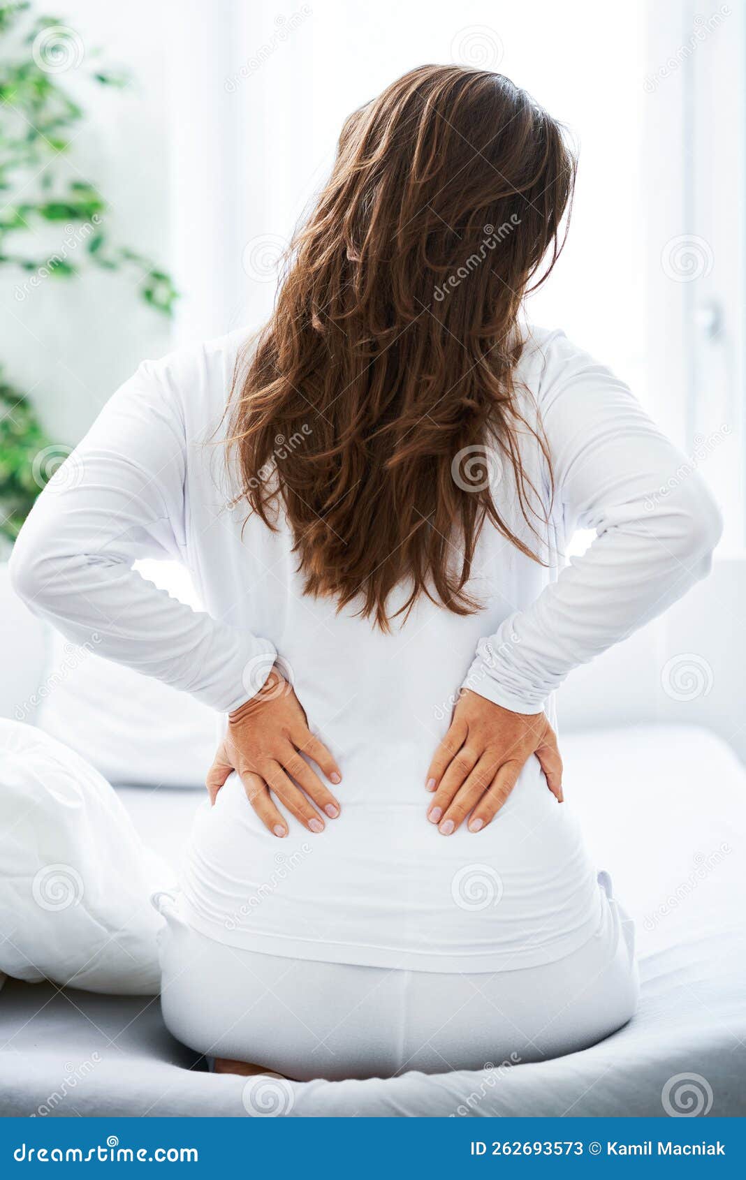 Young Brunet Woman Withe Her Back Problem in the Bed Stock Image ...
