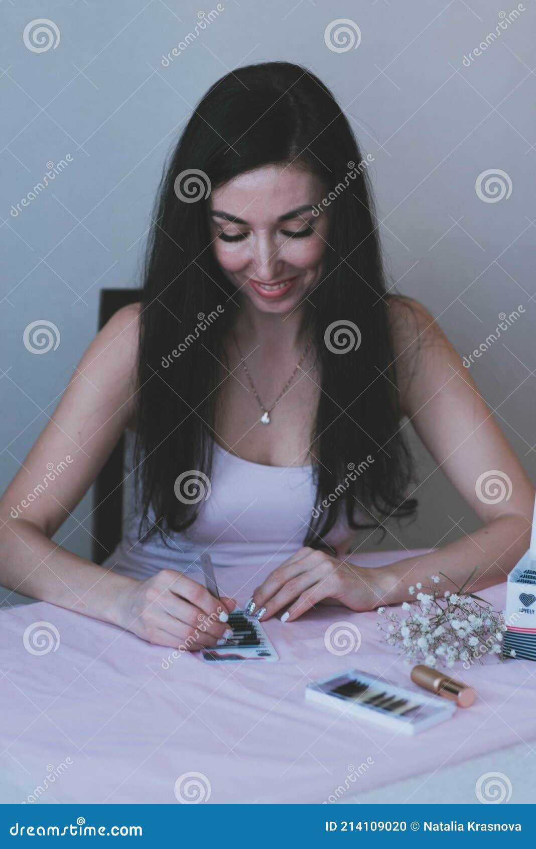 Brunette Girl In Purple Top Smiling While Sitting At The Table Stock
