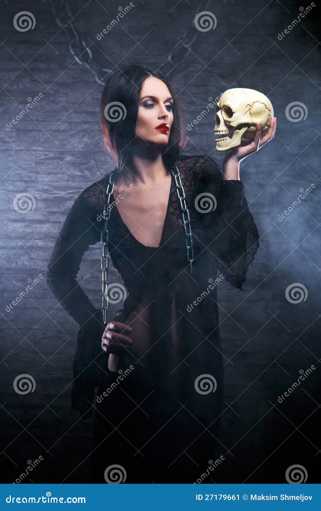 A Young Brunette Witch Holding A Human Skull Royalty-Free Stock Photo ...