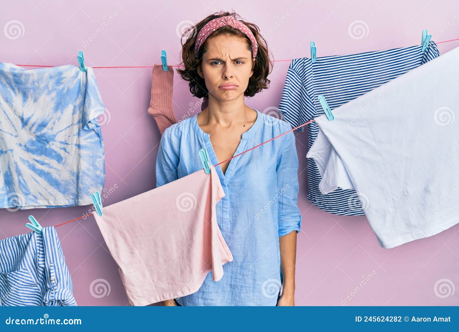 Young Brunette Woman Doing Laundry Around String Hangs Depressed and ...