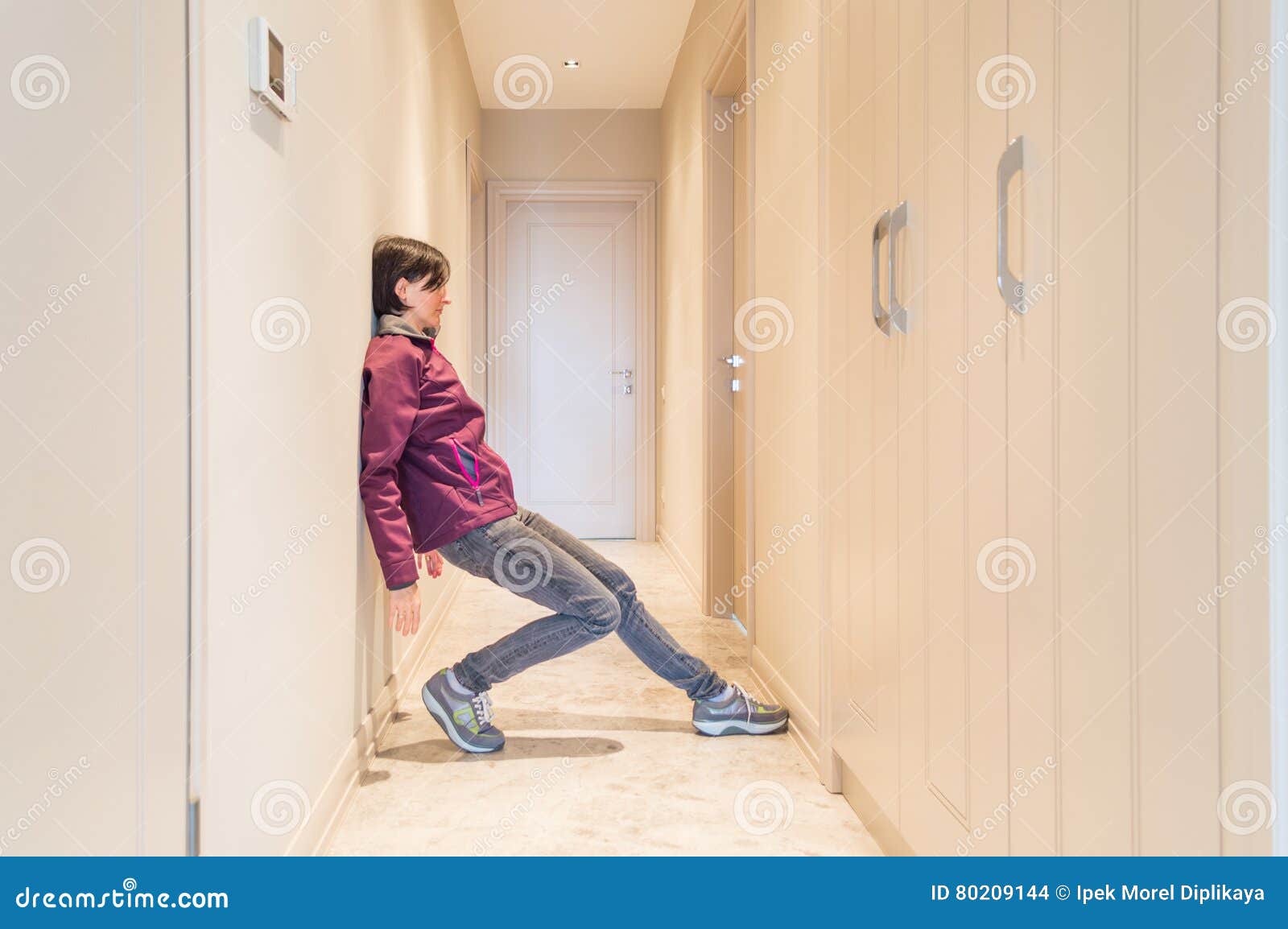 Young Brunette Woman Leaning on the Wall Stock Photo - Image of hall ...