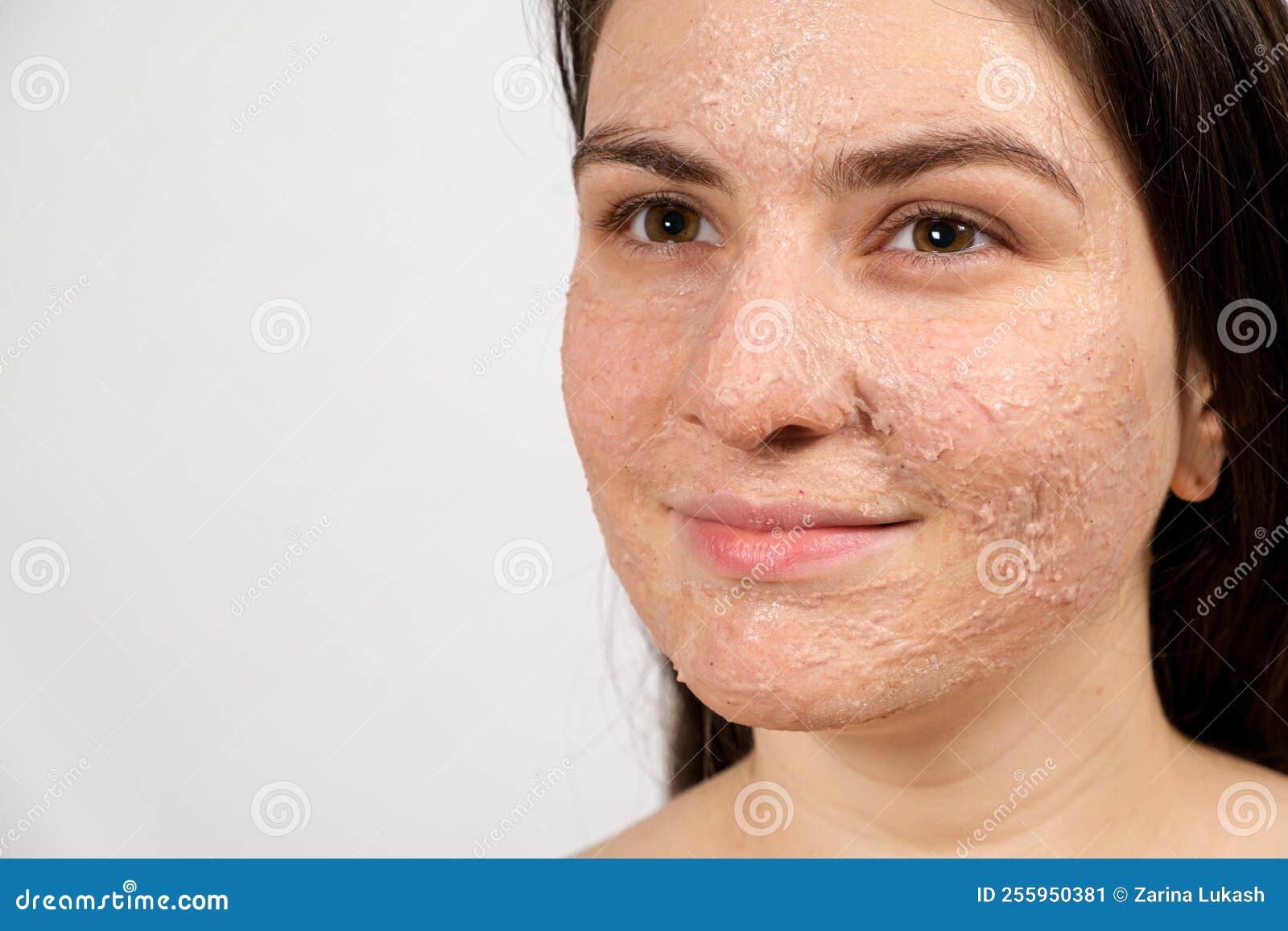 A Young Brunette Woman Makes Cleansing Facial Treatments A Mask Or