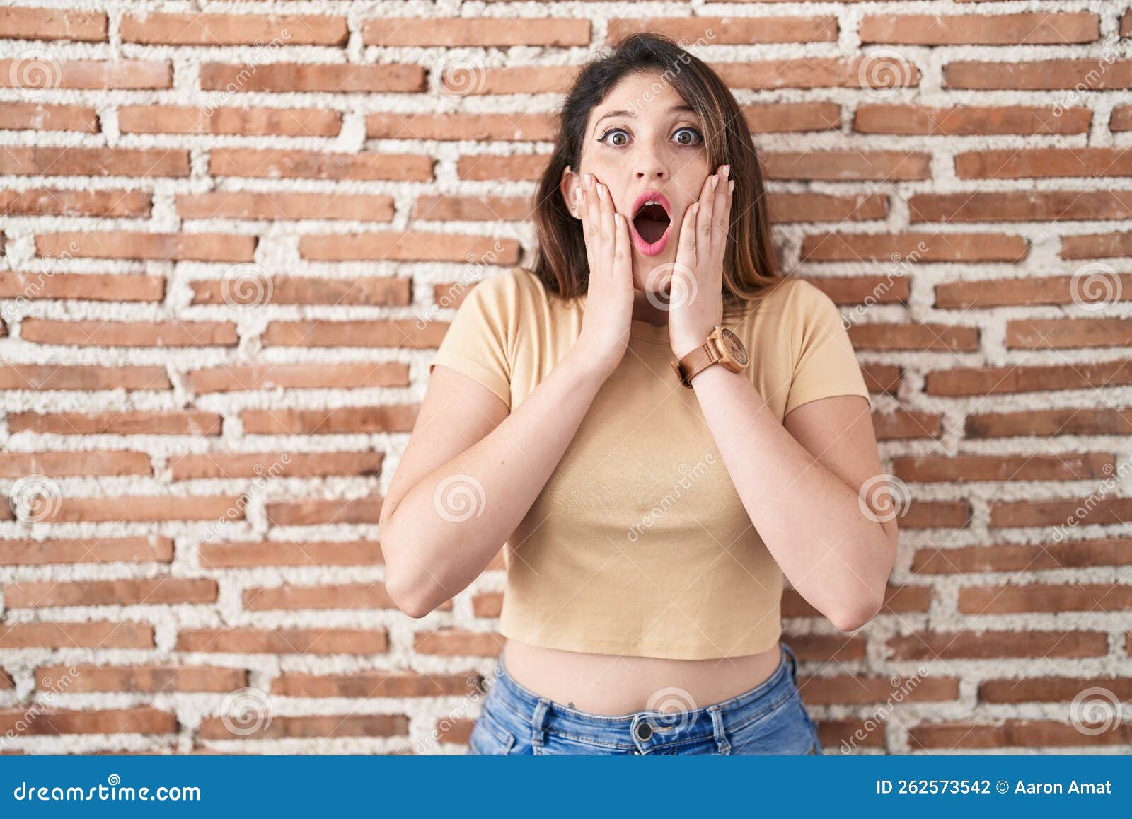 Young Brunette Woman Standing Over Bricks Wall Afraid and Shocked ...