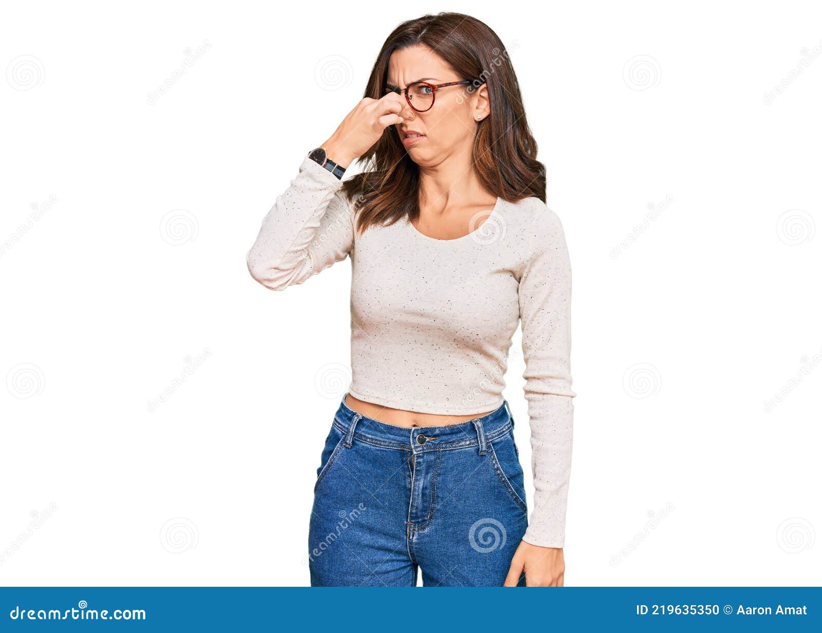 Young Brunette Woman Wearing Casual Clothes And Glasses Smelling