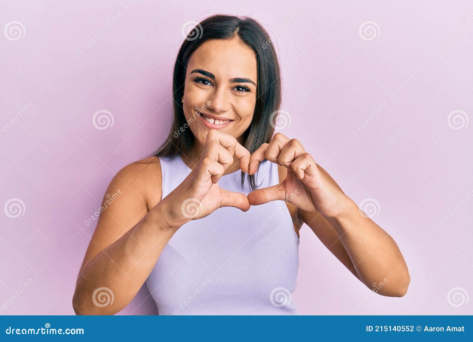 Young Brunette Woman Wearing Casual Clothes Smiling In Love Doing Heart