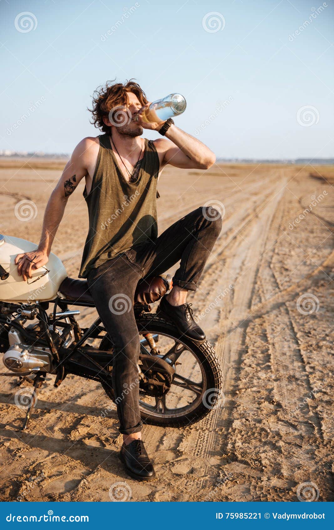 Young Brutal Man Sitting on His Motorcycle and Drinking Water Stock ...