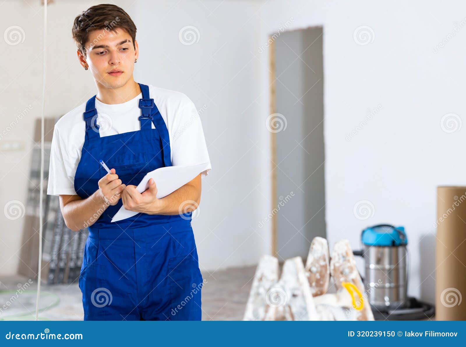 Young Builder Making Checklist while Planning Indoor Building Overhaul ...