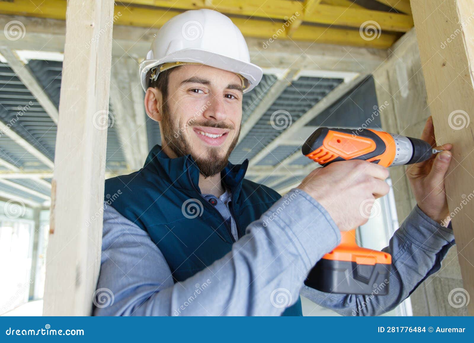 Young Builder Using Cordless Drill Stock Photo - Image of construction ...